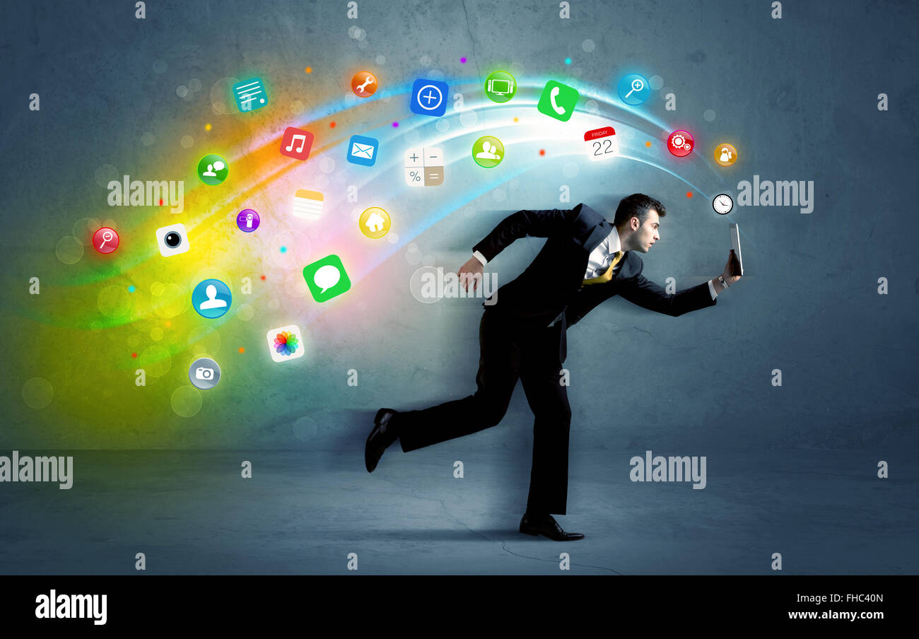 Running businessman with application icons from device Stock Photo - Alamy