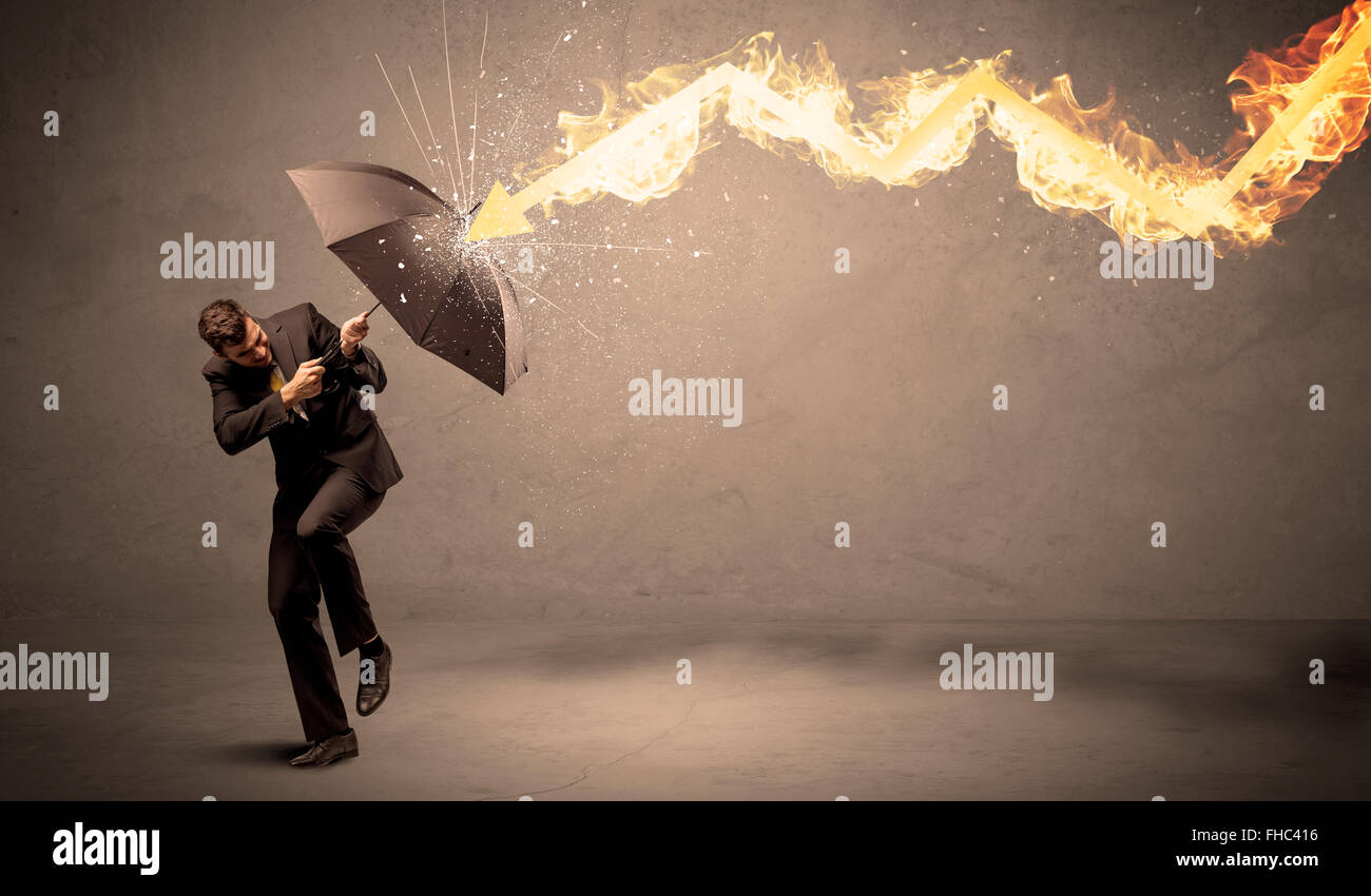 Business man defending himself from a fire arrow with an umbrella Stock ...
