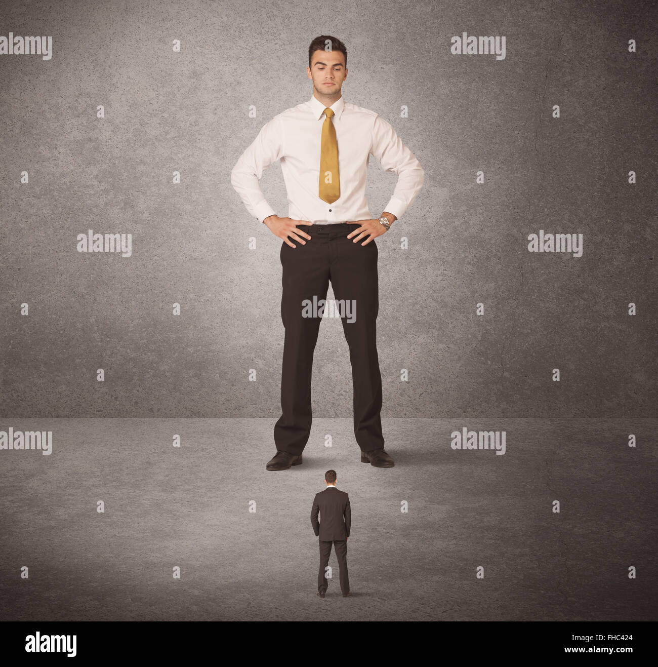 Big business man looking at small worker Stock Photo - Alamy