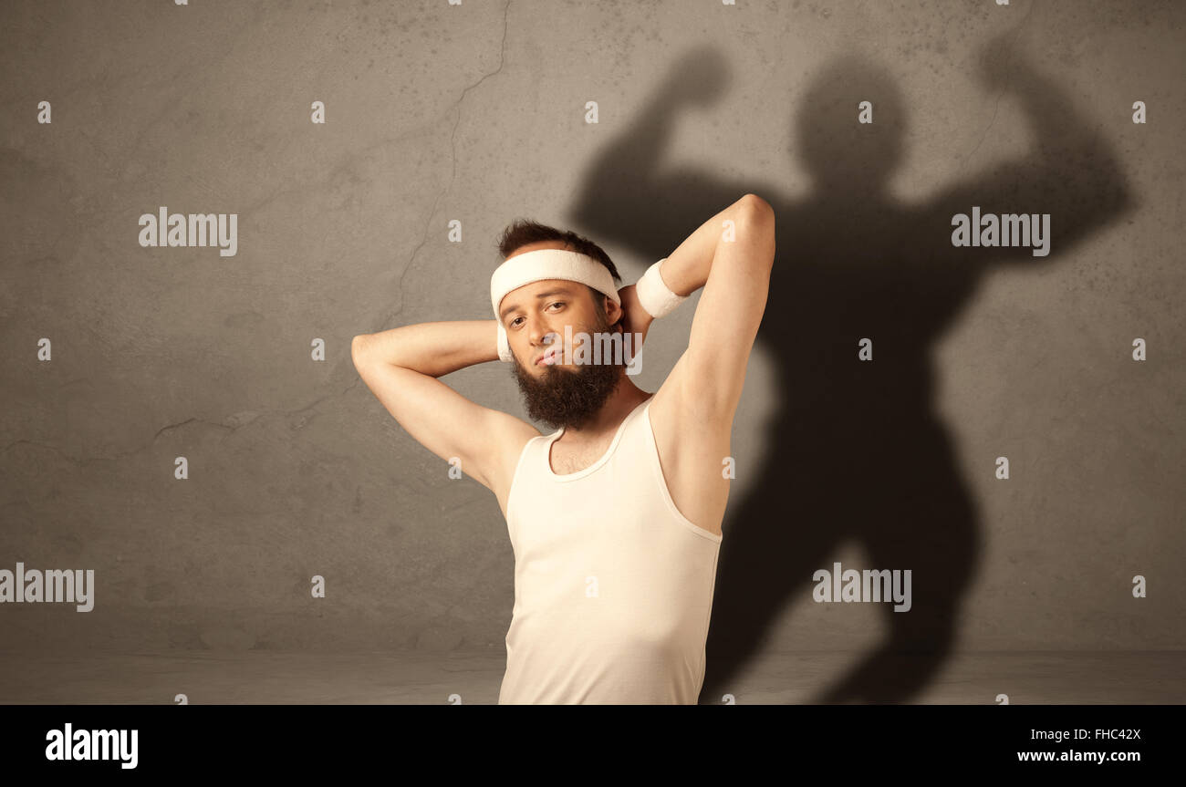 Skinny man with musculous shadow Stock Photo - Alamy