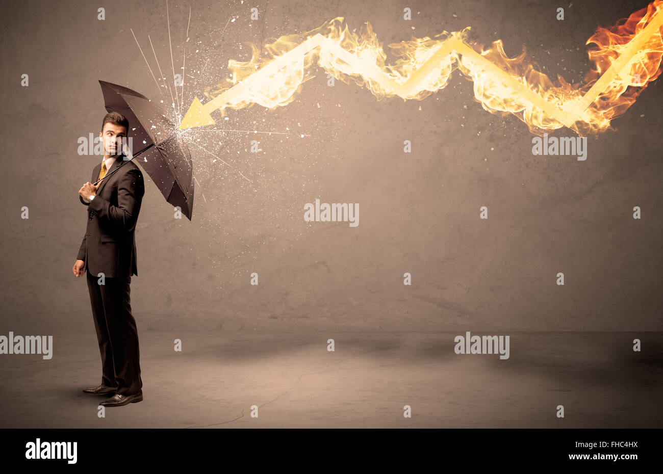 Business man defending himself from a fire arrow with an umbrella Stock ...