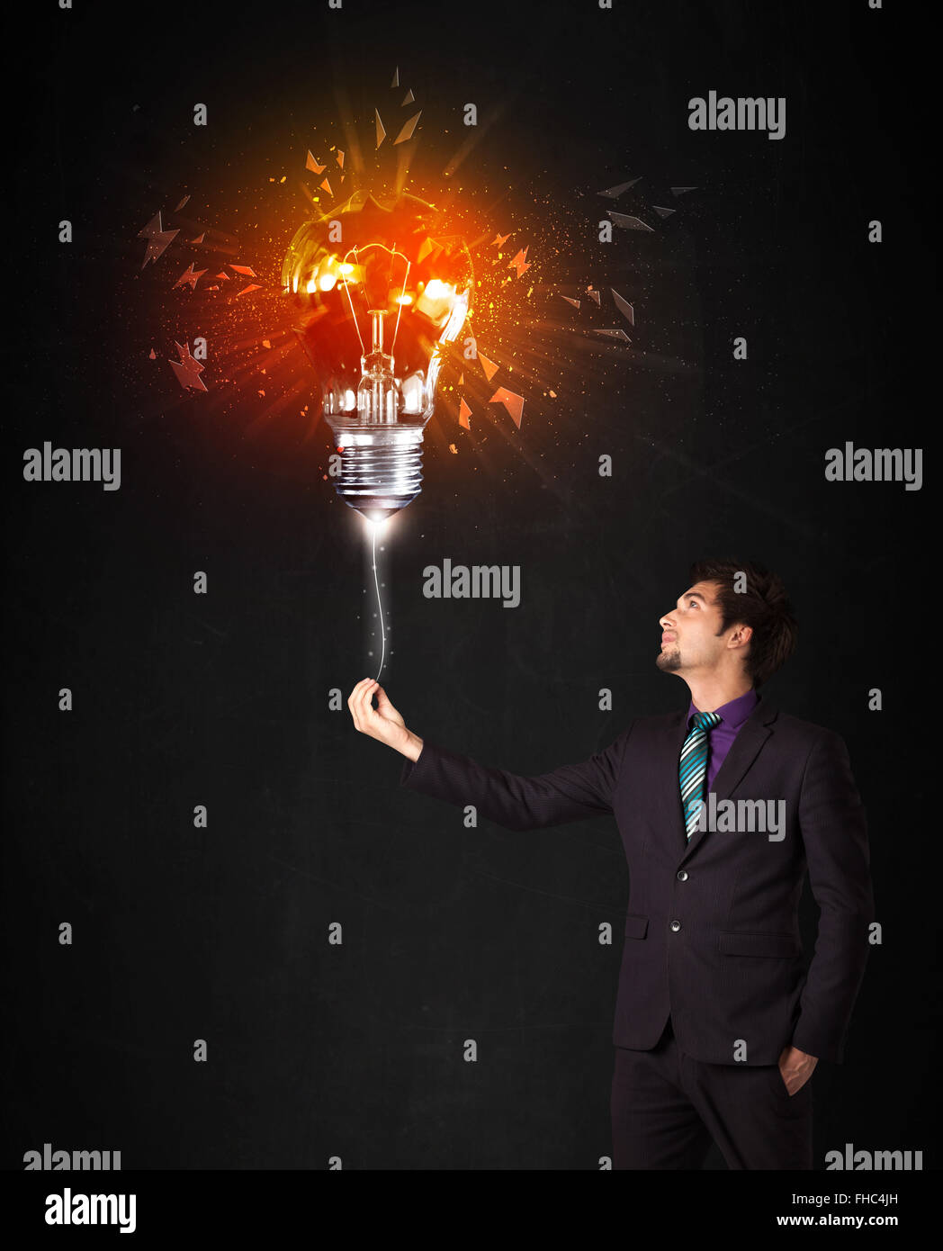 Businessman with an explosion bulb Stock Photo - Alamy