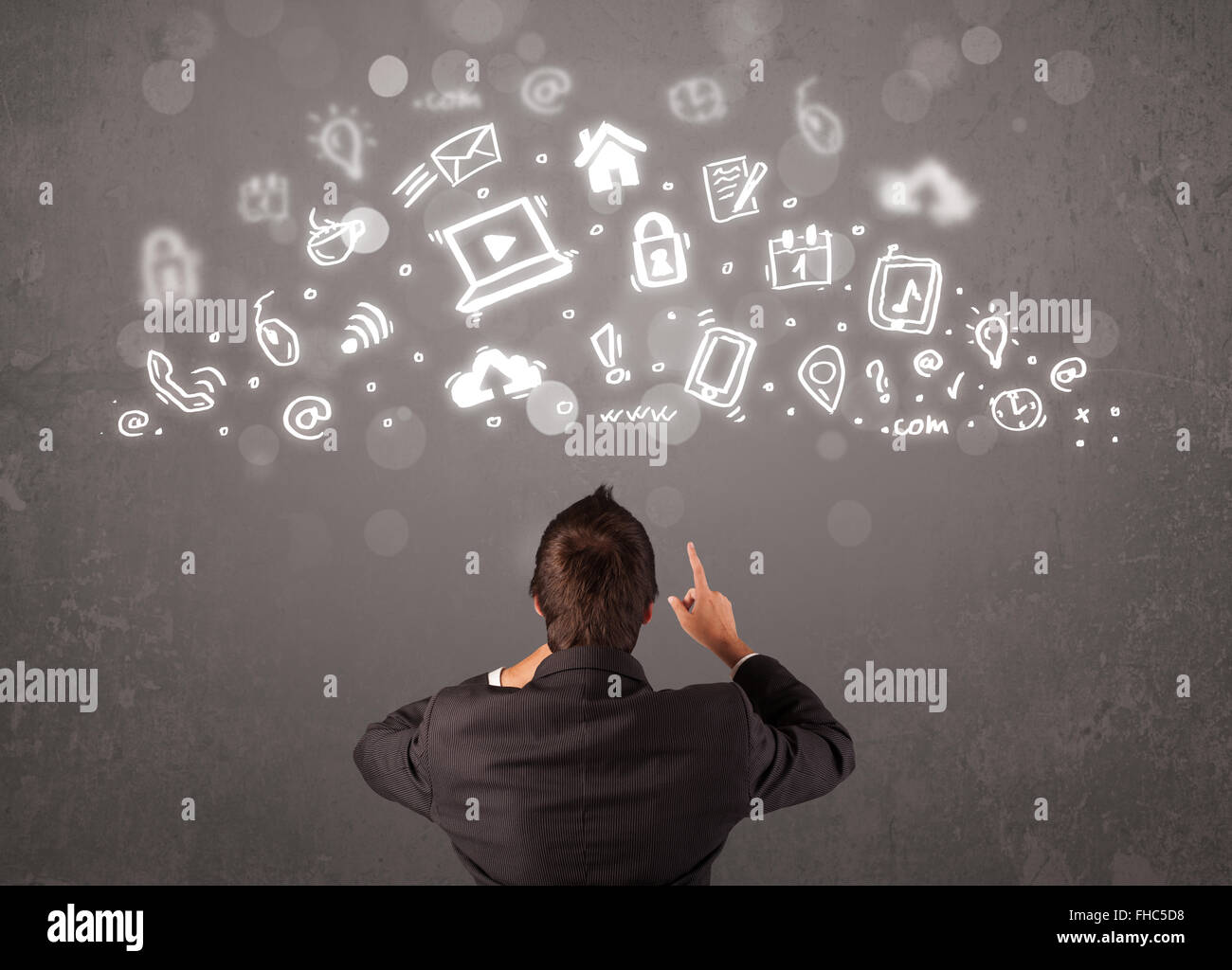Business man looking at modern icons and symbols Stock Photo - Alamy
