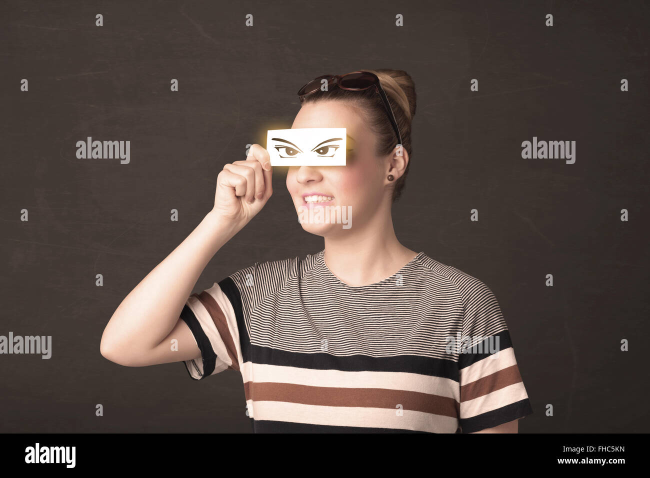 Cool youngster looking with a paper hand drawn eyes Stock Photo - Alamy