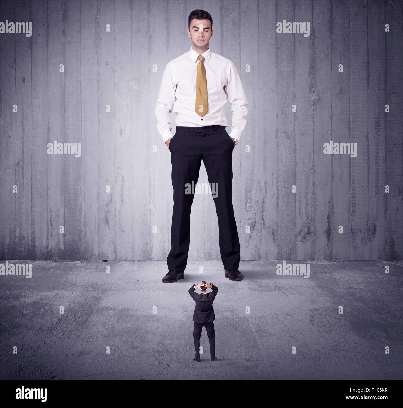 Huge boss lokking at small business man Stock Photo - Alamy