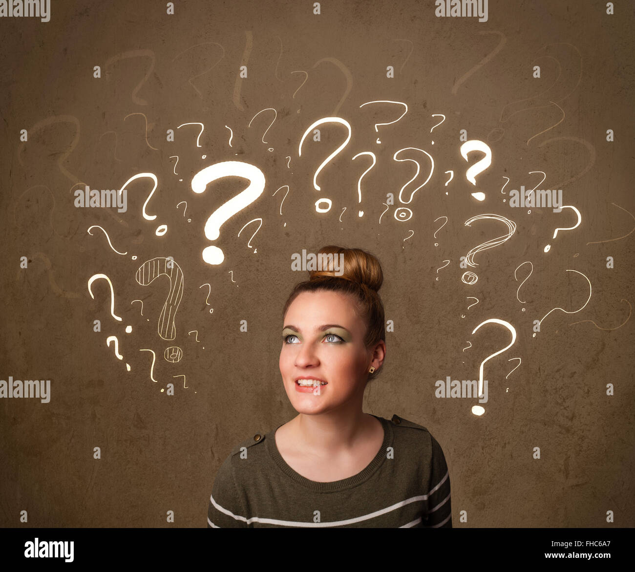 girl with question mark symbols around her head Stock Photo - Alamy