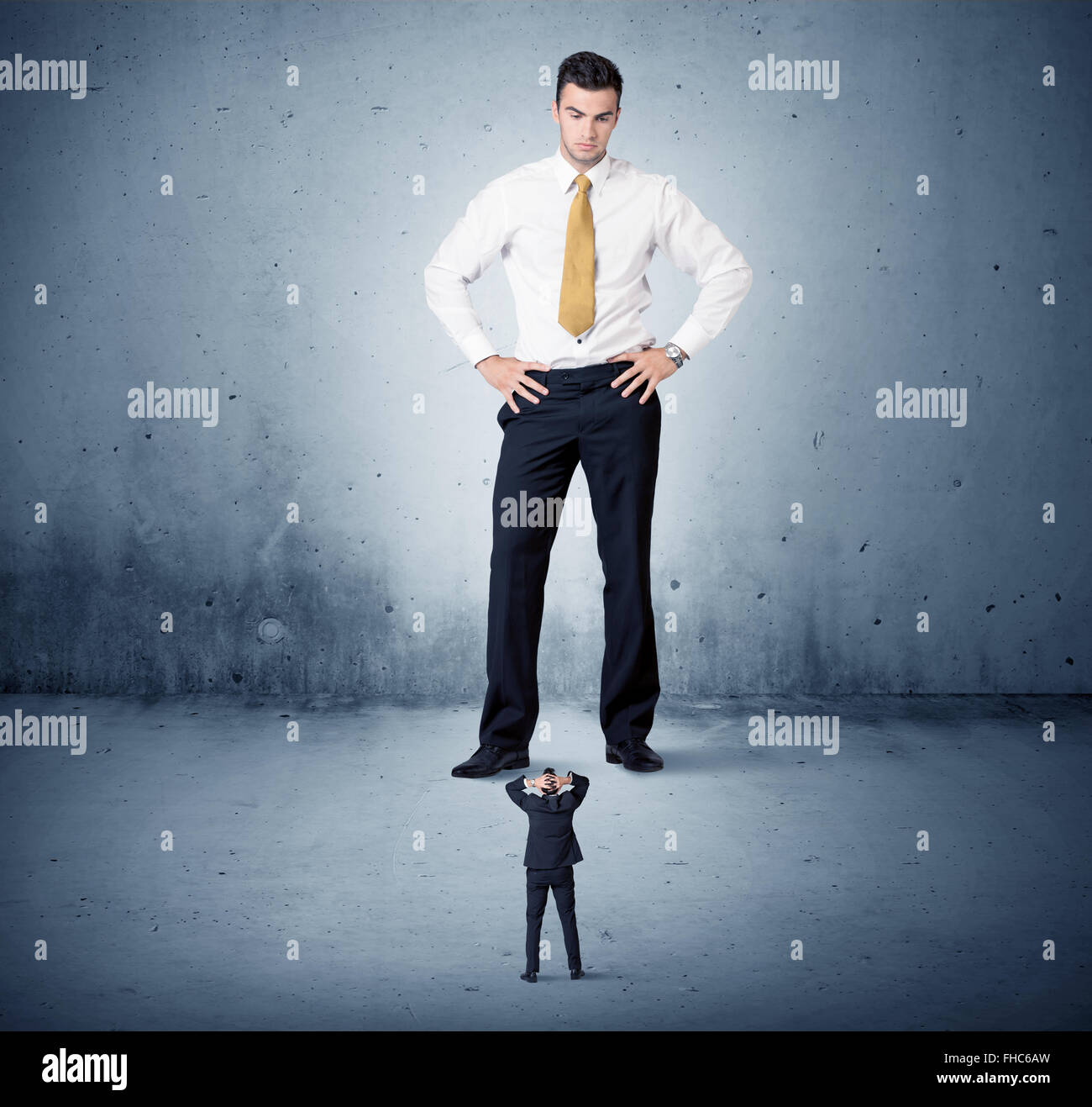 Angry huge business man lokking at small guy Stock Photo - Alamy