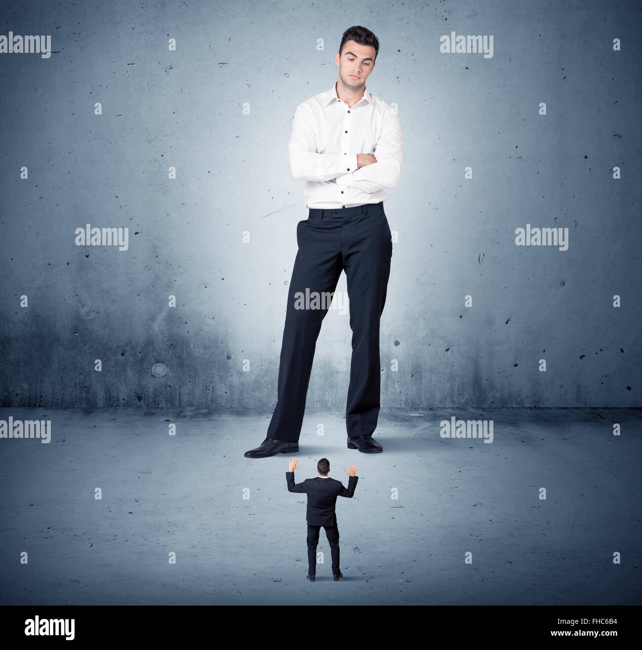 Angry huge business man lokking at small guy Stock Photo - Alamy