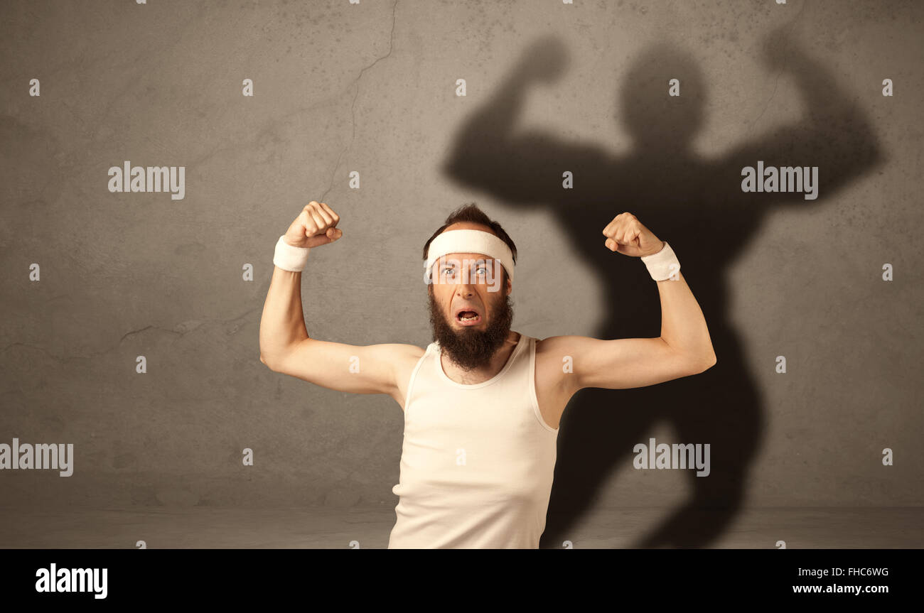 Skinny man with musculous shadow Stock Photo - Alamy