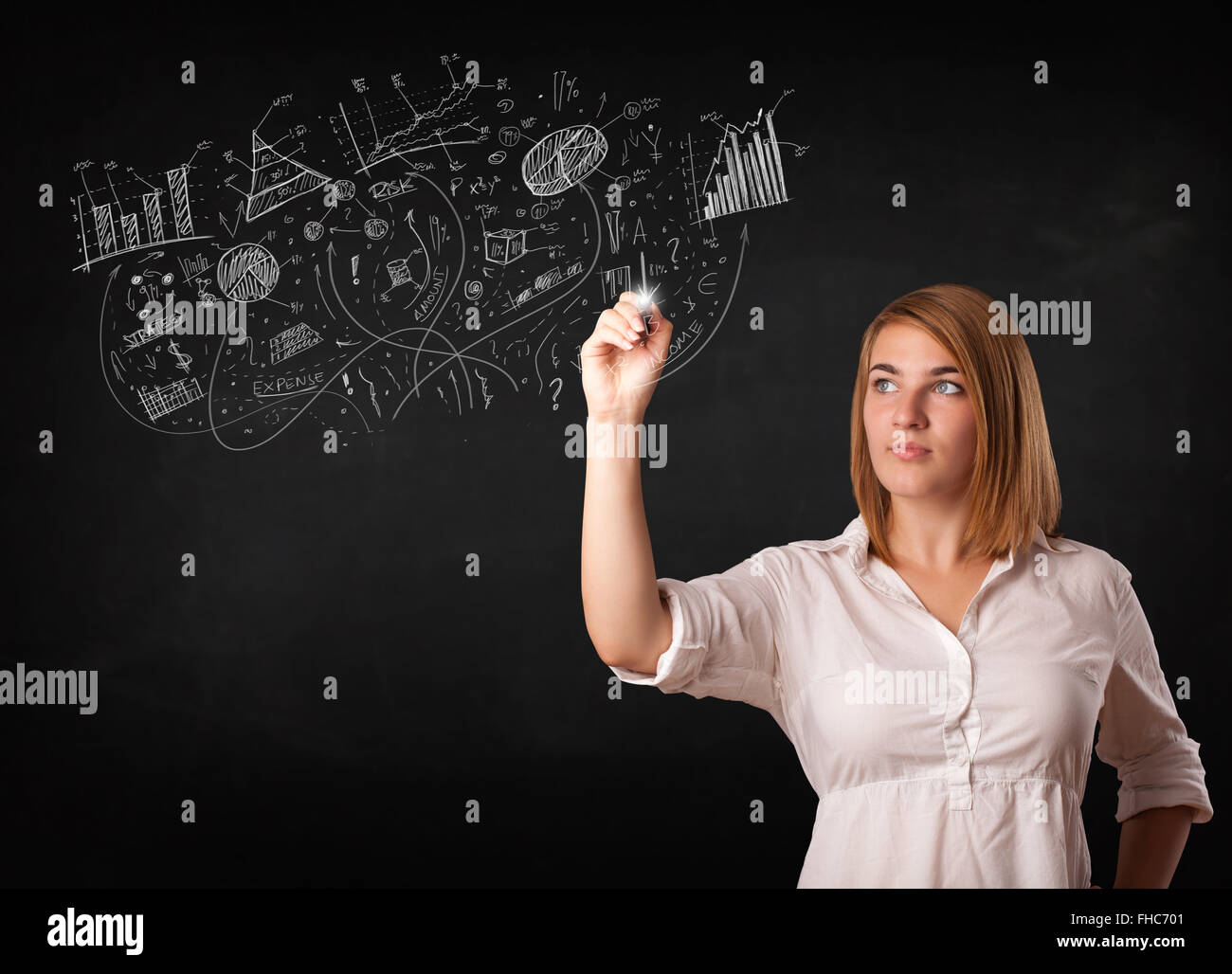 Pretty girl sketching graphs and diagrams on wall Stock Photo - Alamy