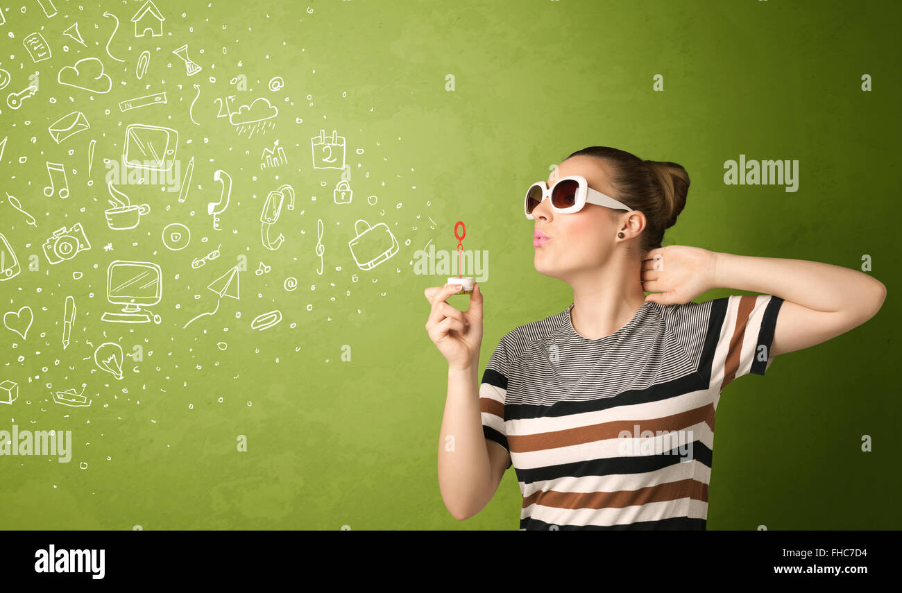 Cute girl blowing hand drawn media icons and symbols Stock Photo - Alamy