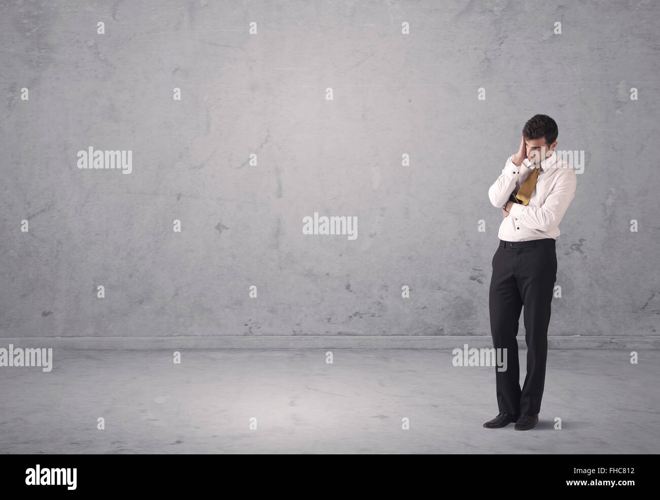 Young businessman standing confused Stock Photo - Alamy
