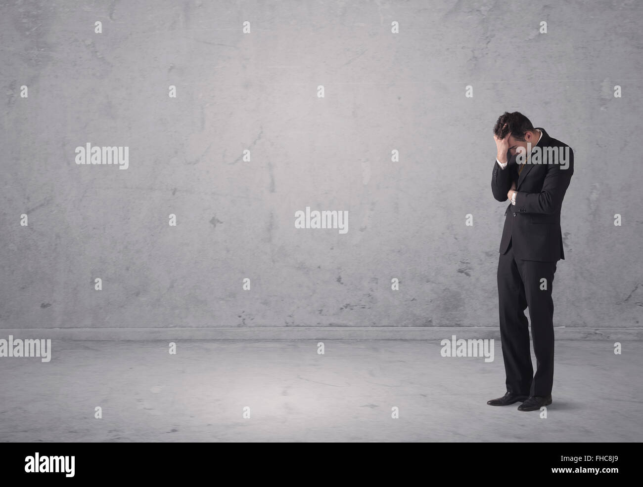 Young businessman standing confused Stock Photo - Alamy