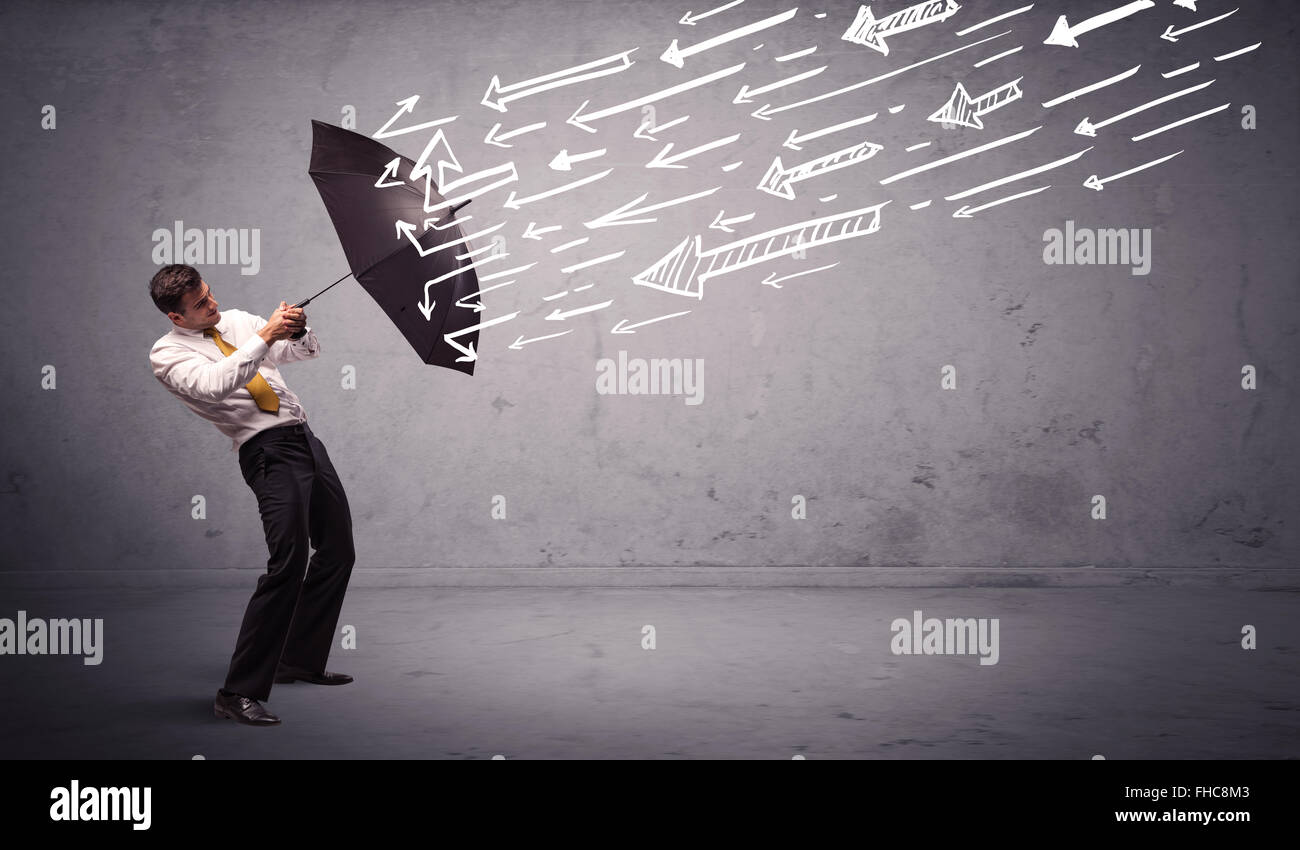 Business man standing with umbrella and drawn arrows hitting him Stock ...
