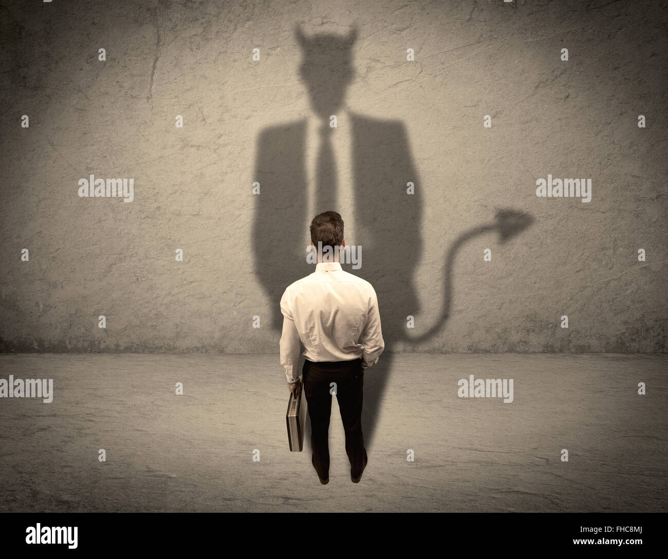 Salesman facing his own devil shadow Stock Photo - Alamy