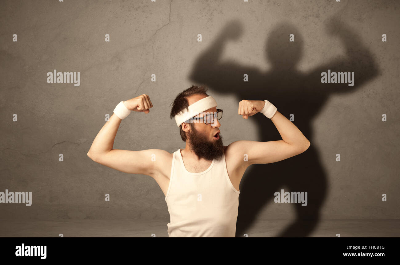 Skinny man with musculous shadow Stock Photo - Alamy