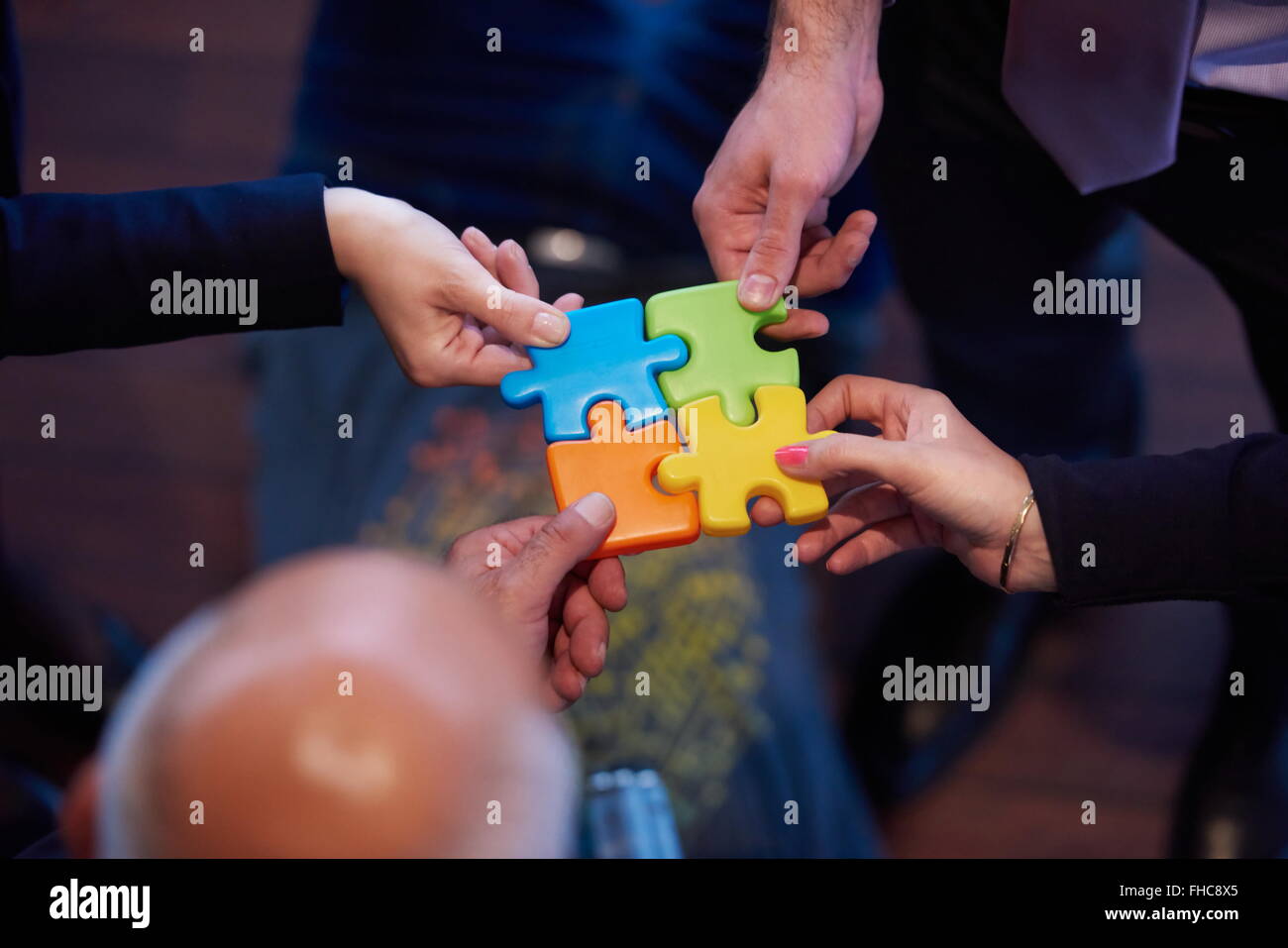 assembling jigsaw puzzle Stock Photo - Alamy
