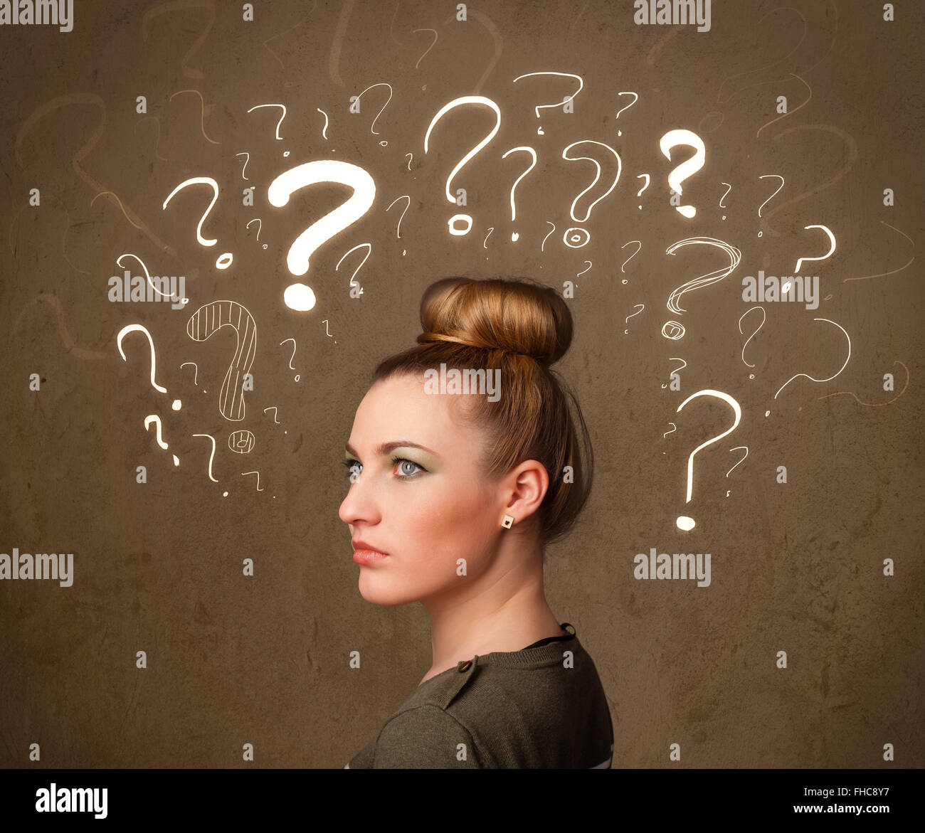 girl with question mark symbols around her head Stock Photo - Alamy