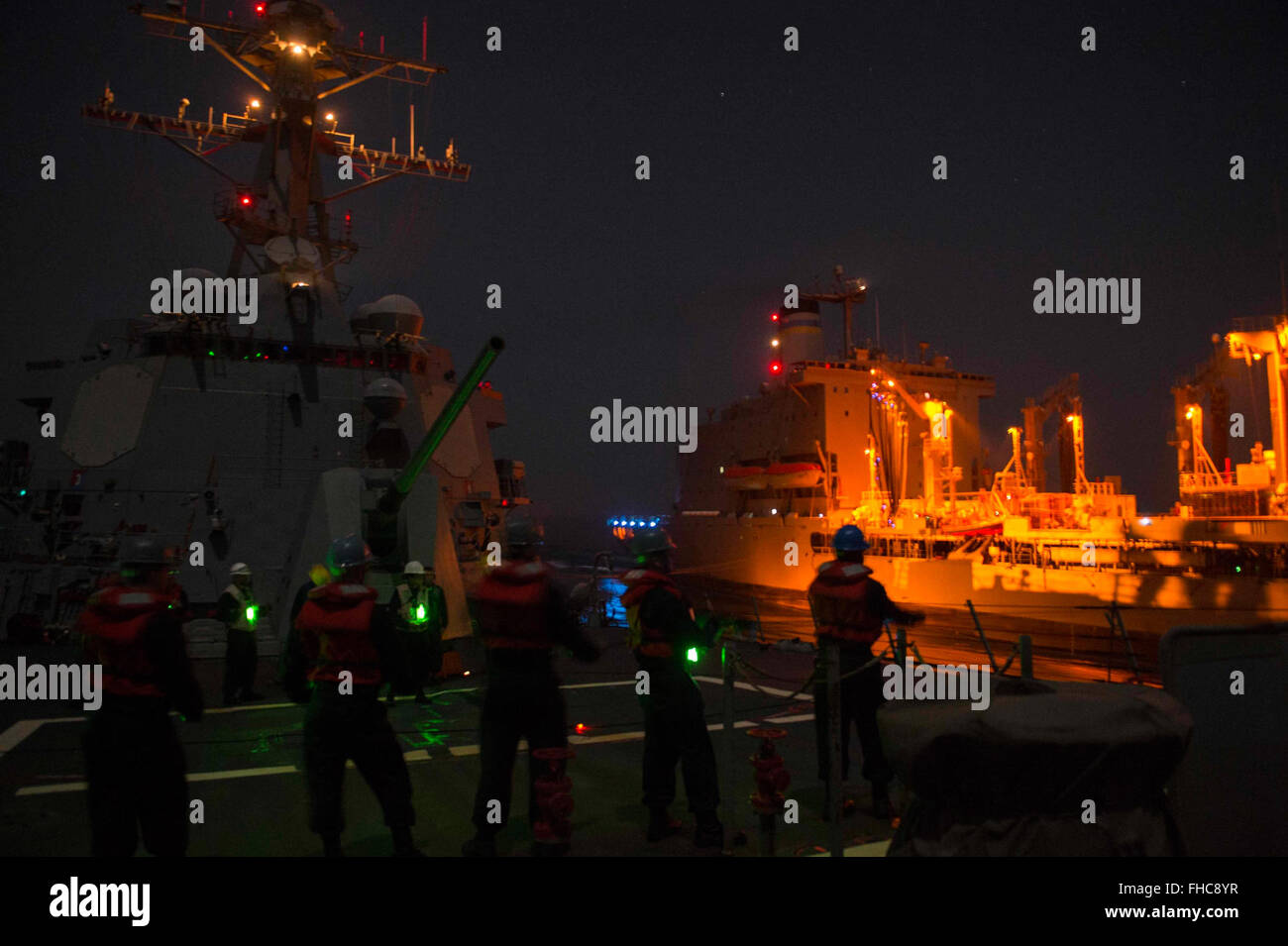 The USS Farragut undergoing replenishment operations with the USNS ...