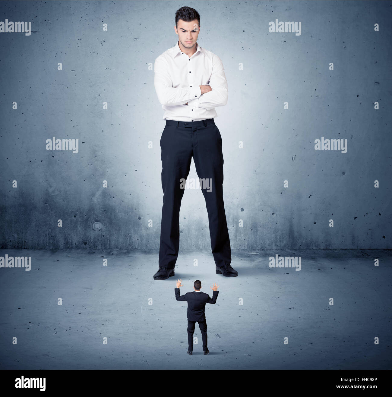 Angry huge business man lokking at small guy Stock Photo - Alamy