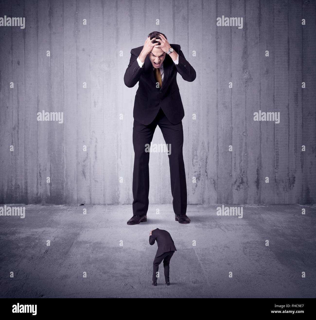 Huge boss lokking at small business man Stock Photo - Alamy