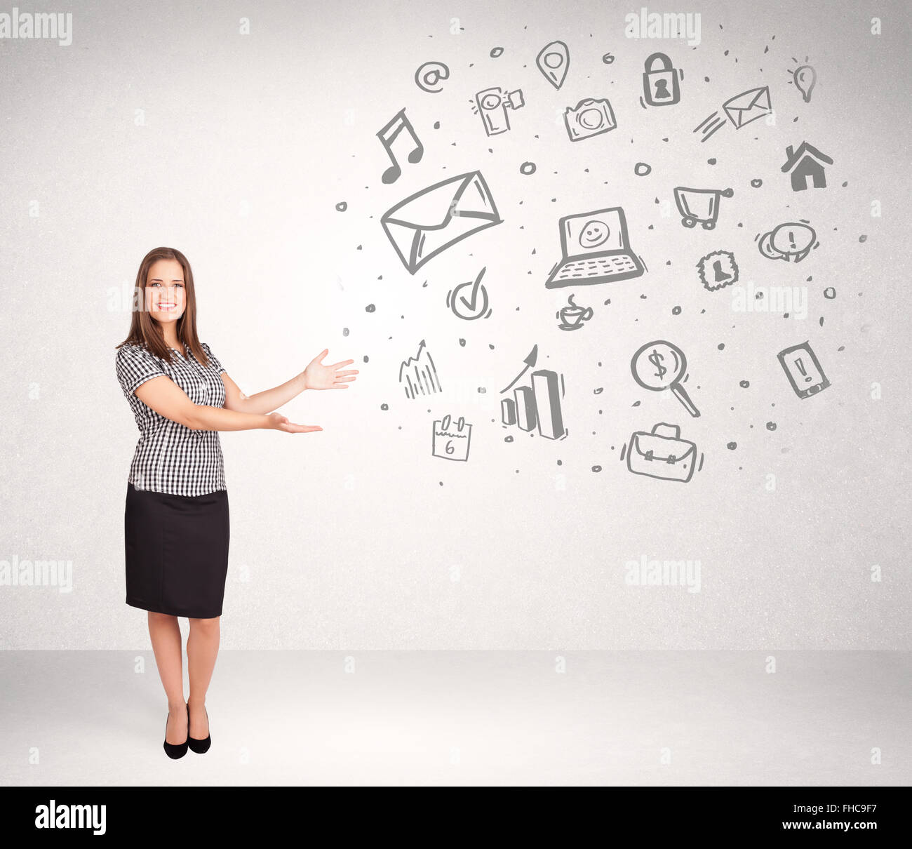 Young business woman presenting hand drawn media icons Stock Photo - Alamy