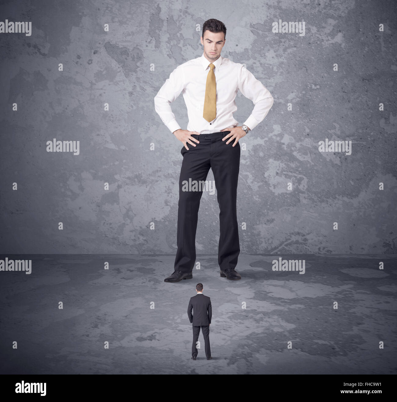 Big boss looking at tiny coworker Stock Photo - Alamy