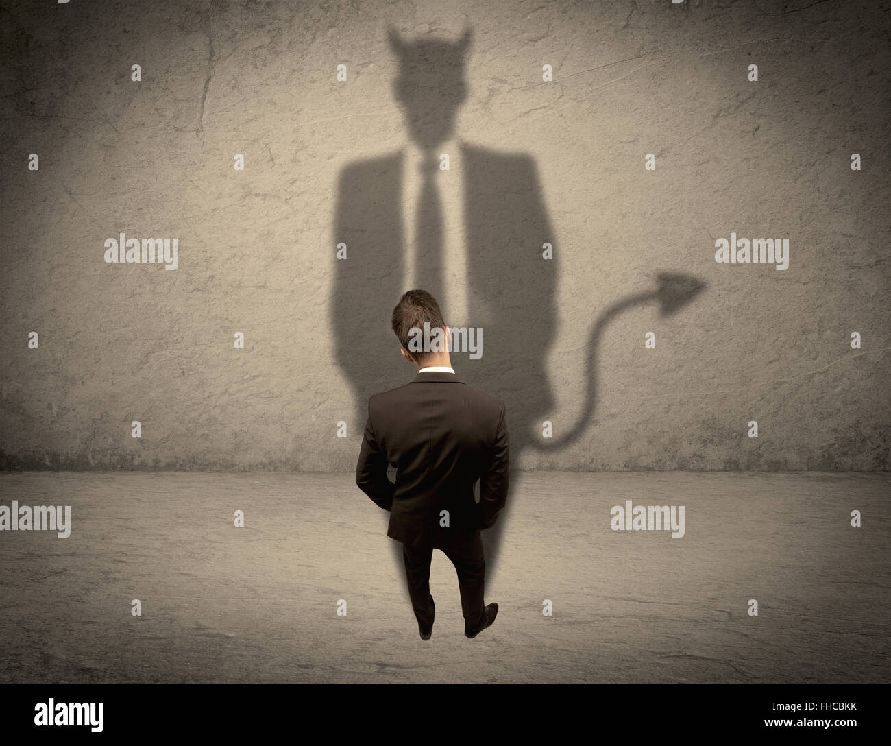 Salesman facing his own devil shadow Stock Photo - Alamy