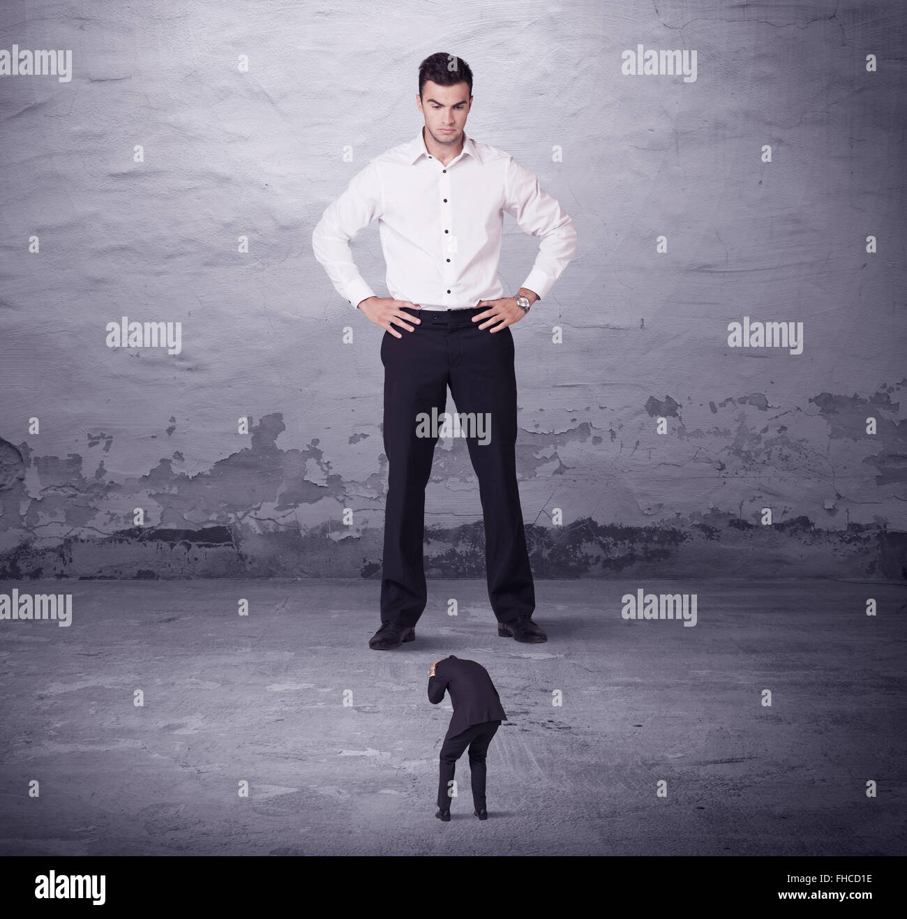 Angry big manager looking at small business man Stock Photo - Alamy