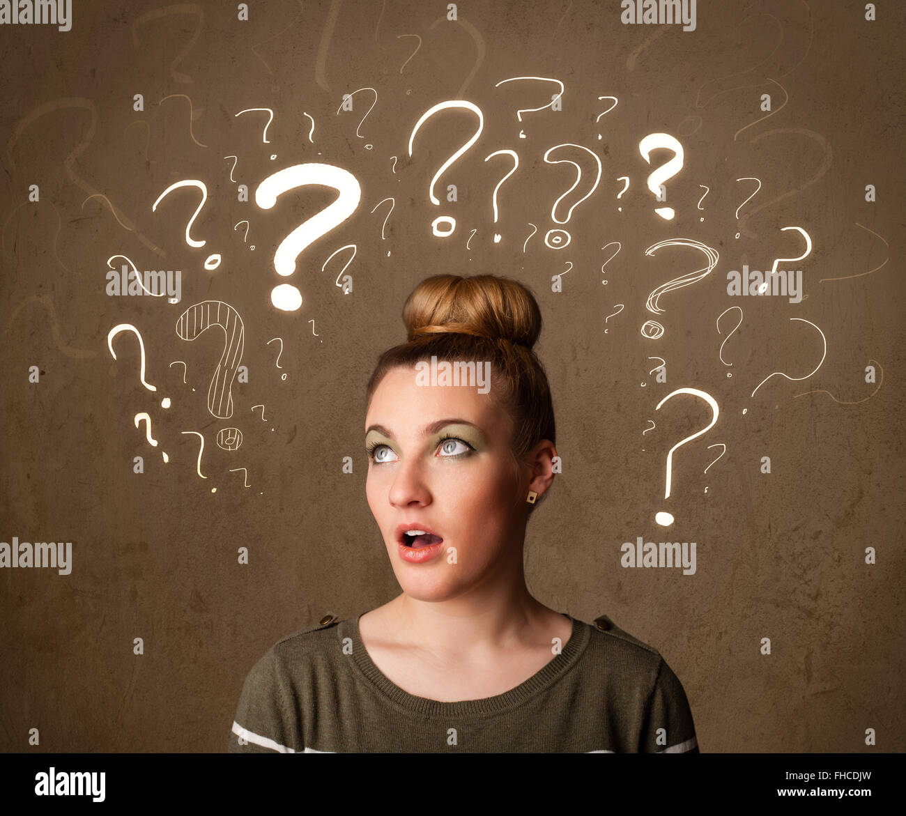 girl with question mark symbols around her head Stock Photo - Alamy
