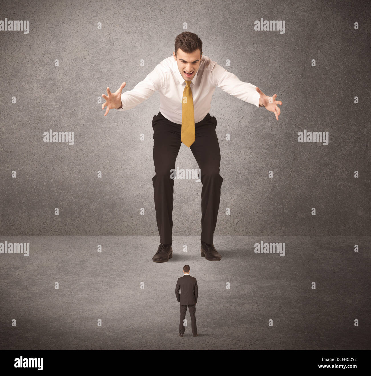 Big business man looking at small worker Stock Photo - Alamy