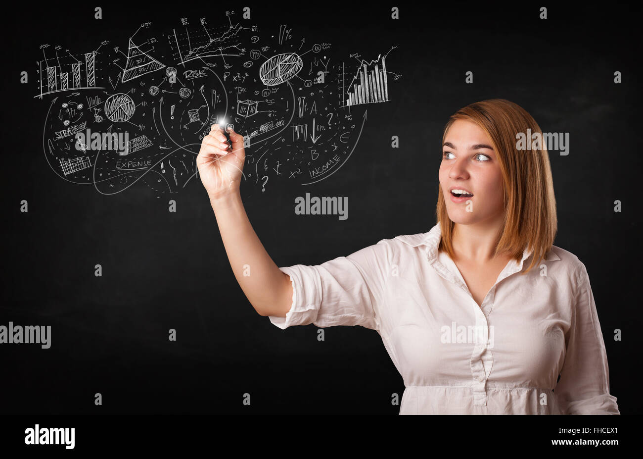 Pretty girl sketching graphs and diagrams on wall Stock Photo - Alamy