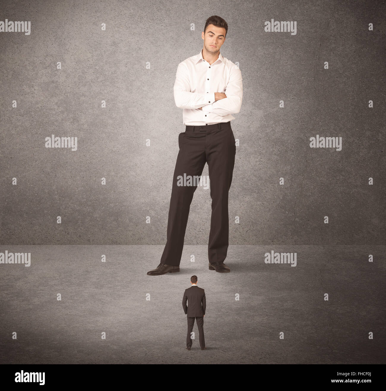 Big business man looking at small worker Stock Photo - Alamy