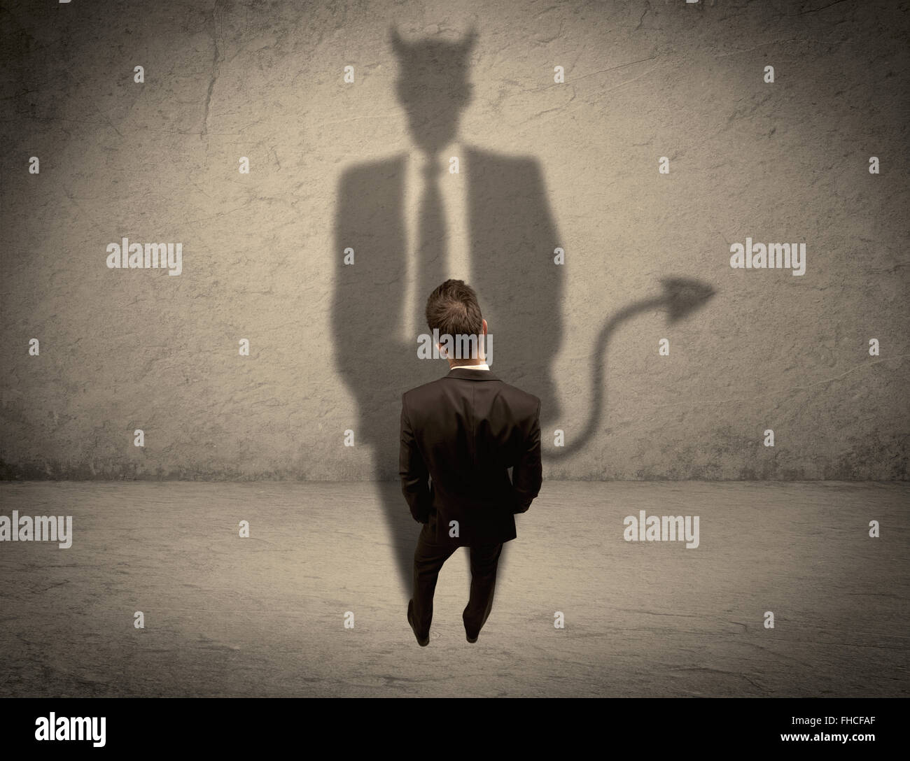 Salesman facing his own devil shadow Stock Photo - Alamy