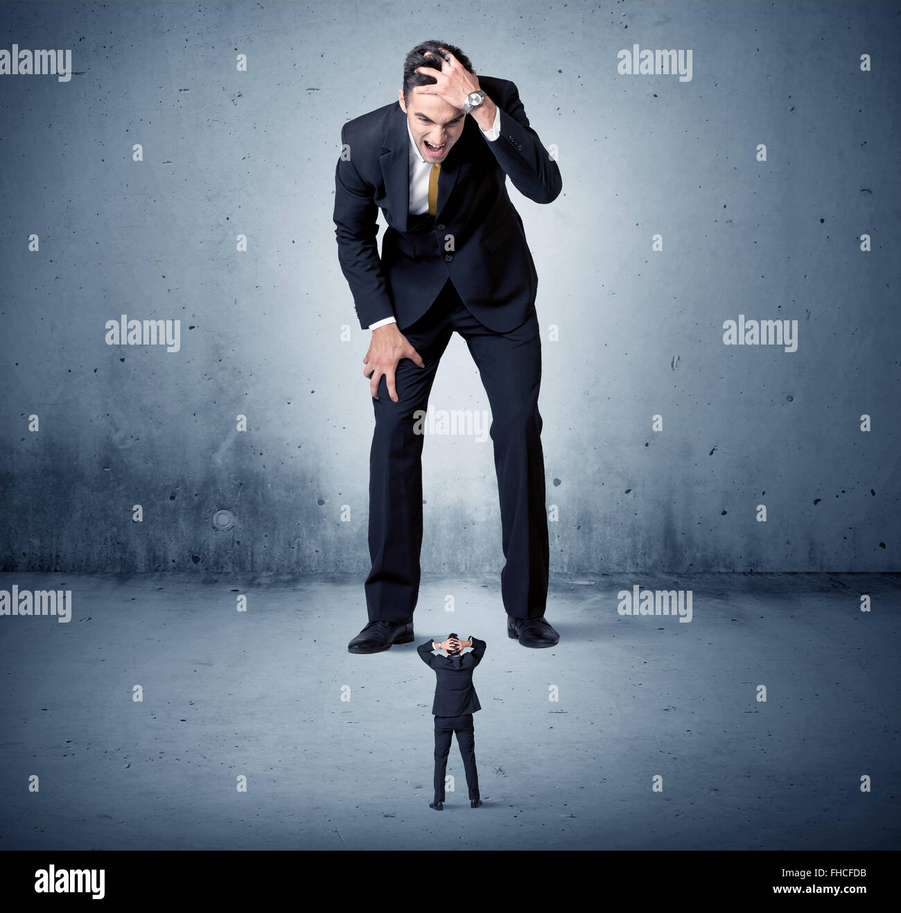 Angry huge business man lokking at small guy Stock Photo - Alamy
