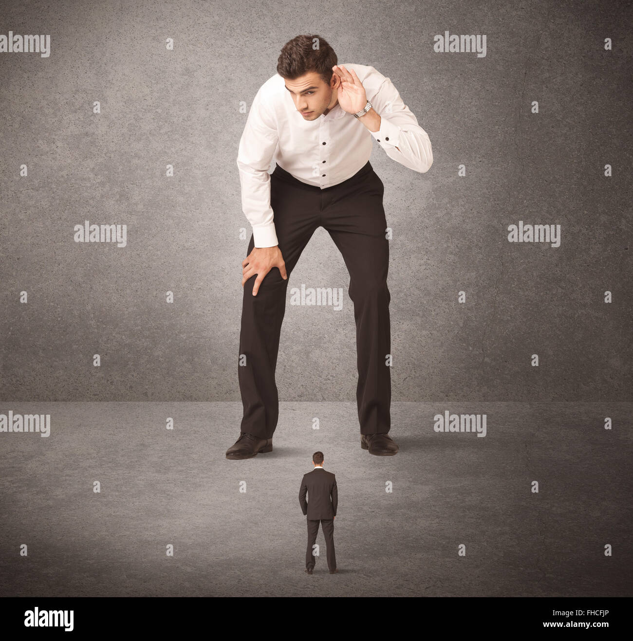 Big business man looking at small worker Stock Photo - Alamy