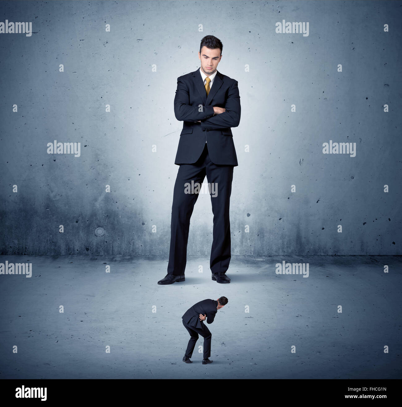Angry huge business man lokking at small guy Stock Photo - Alamy