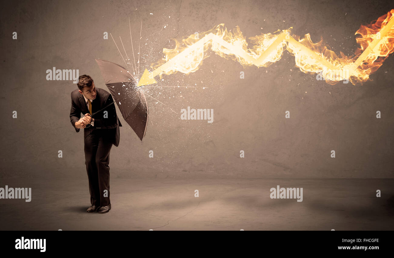 Business man defending himself from a fire arrow with an umbrella Stock ...