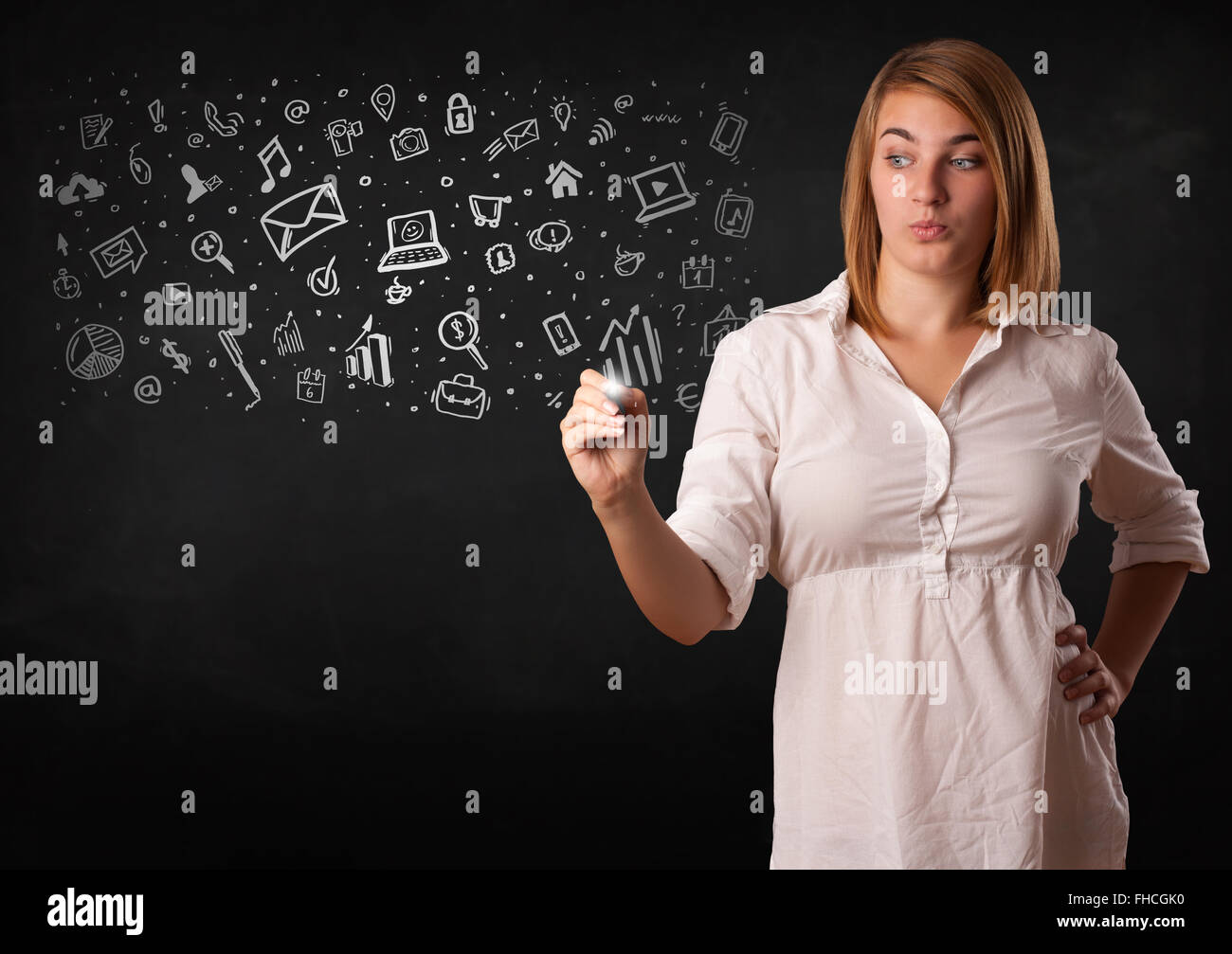 Young woman drawing and sketching icons and symbols Stock Photo - Alamy