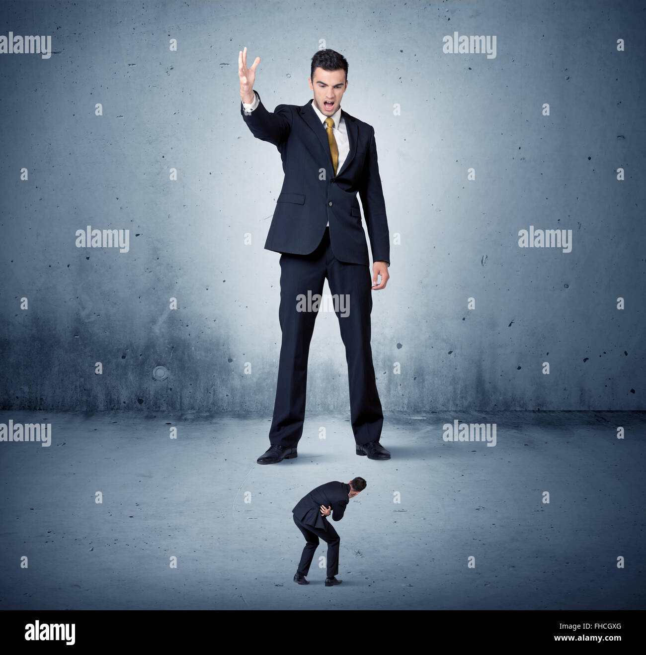Angry huge business man lokking at small guy Stock Photo - Alamy