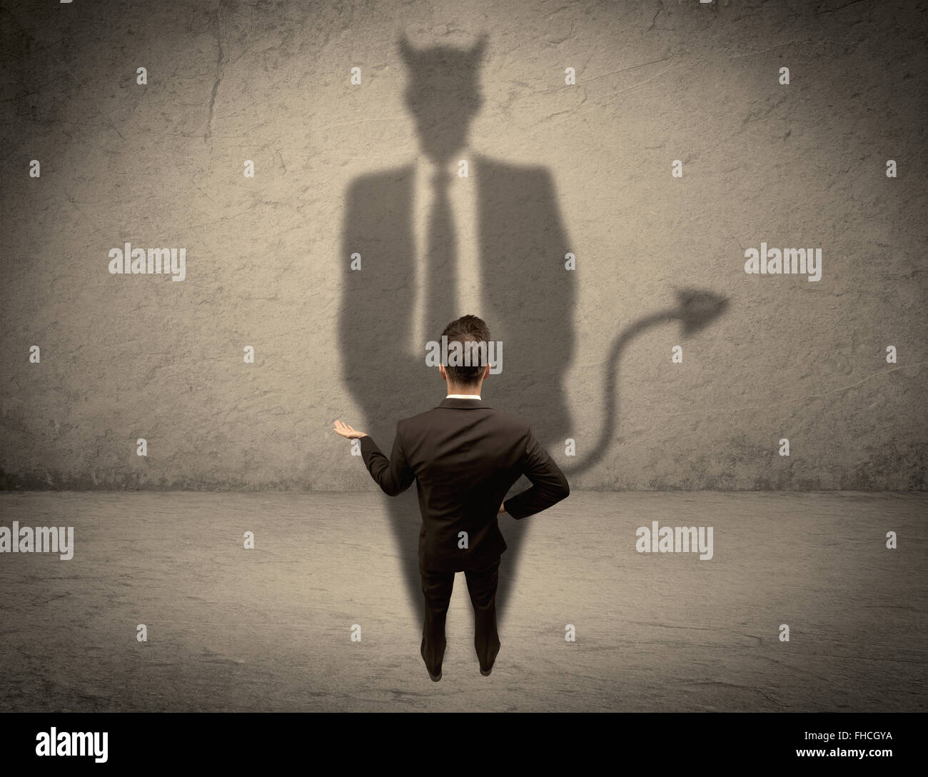 Salesman facing his own devil shadow Stock Photo - Alamy