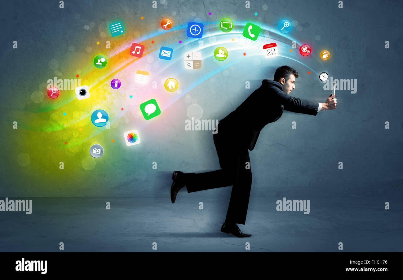 Running businessman with application icons from device Stock Photo - Alamy