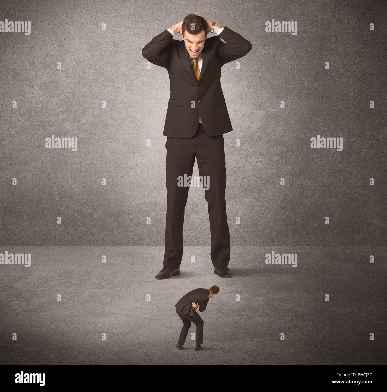 Big business man looking at small worker Stock Photo - Alamy