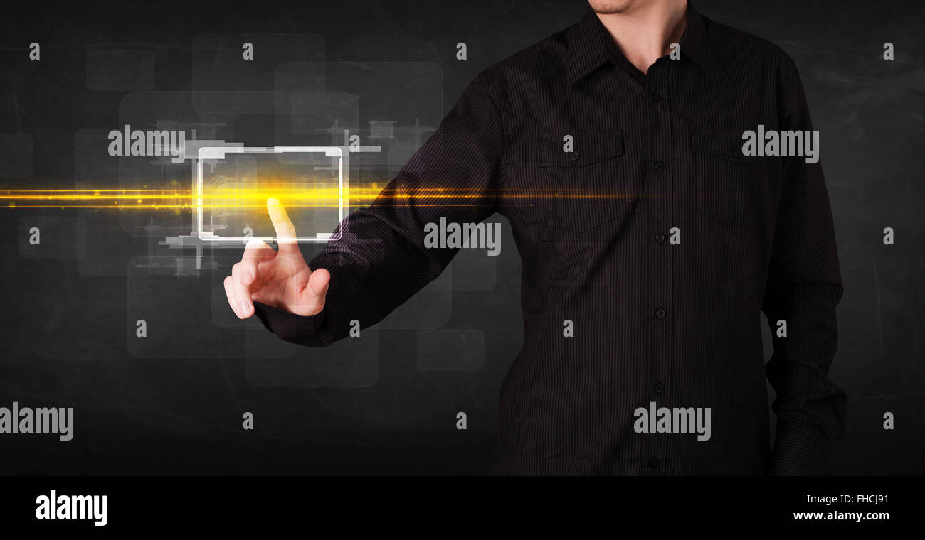Tech business person touching button with orange light beams concept ...
