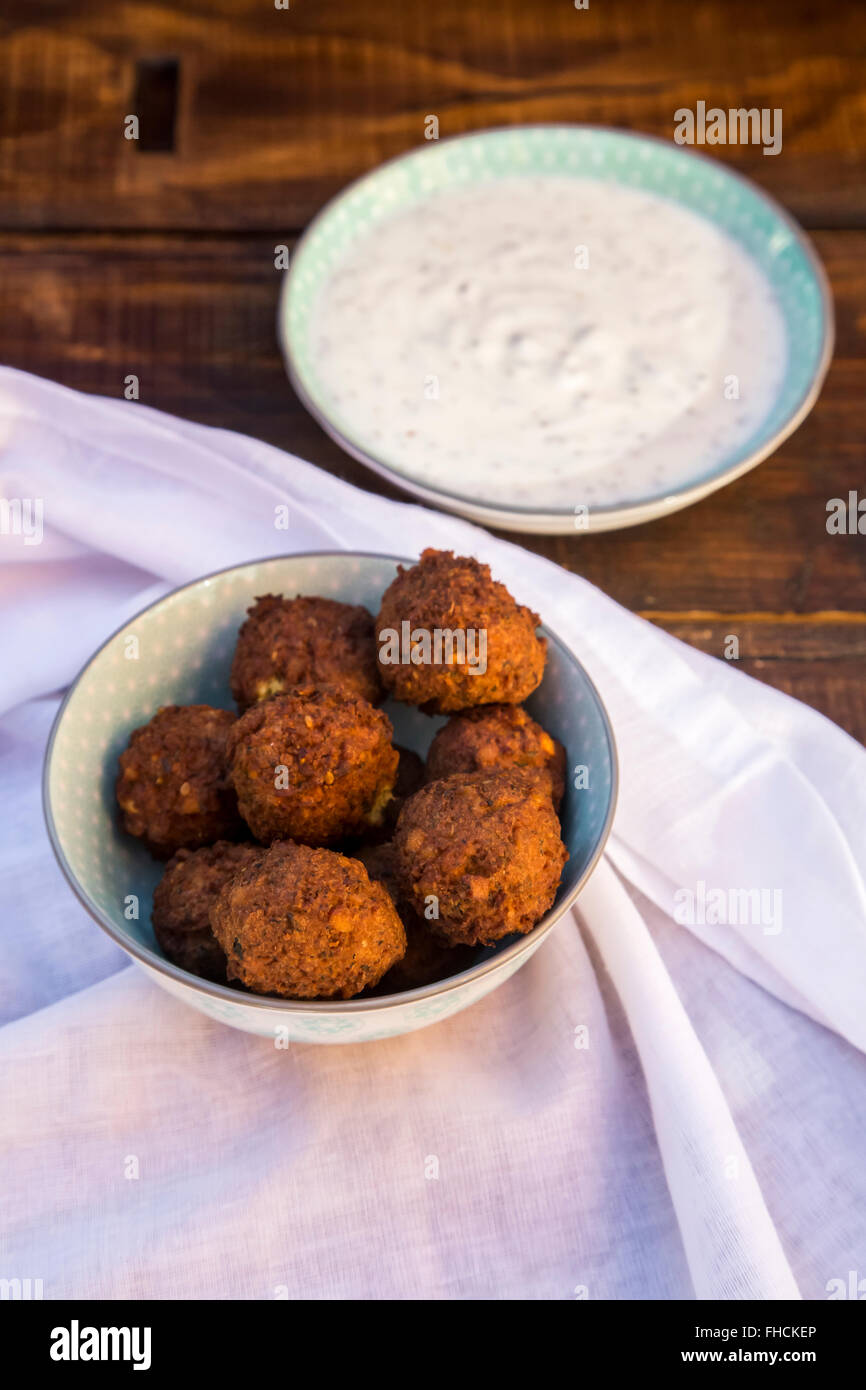 Preparation of falafel, vegetan falafel patties, joghurt in bowl Stock ...