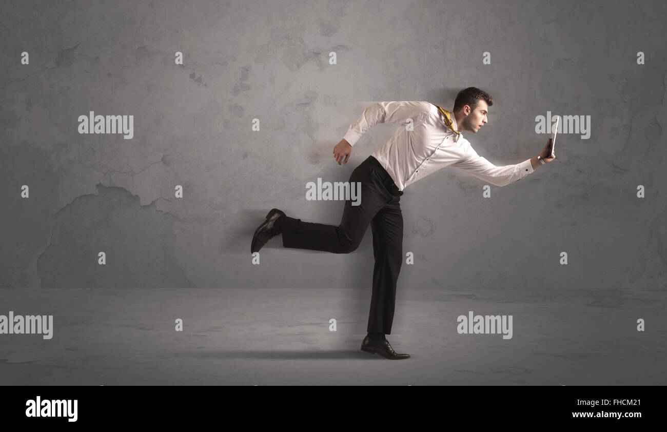 Running businessman with device in hand Stock Photo - Alamy