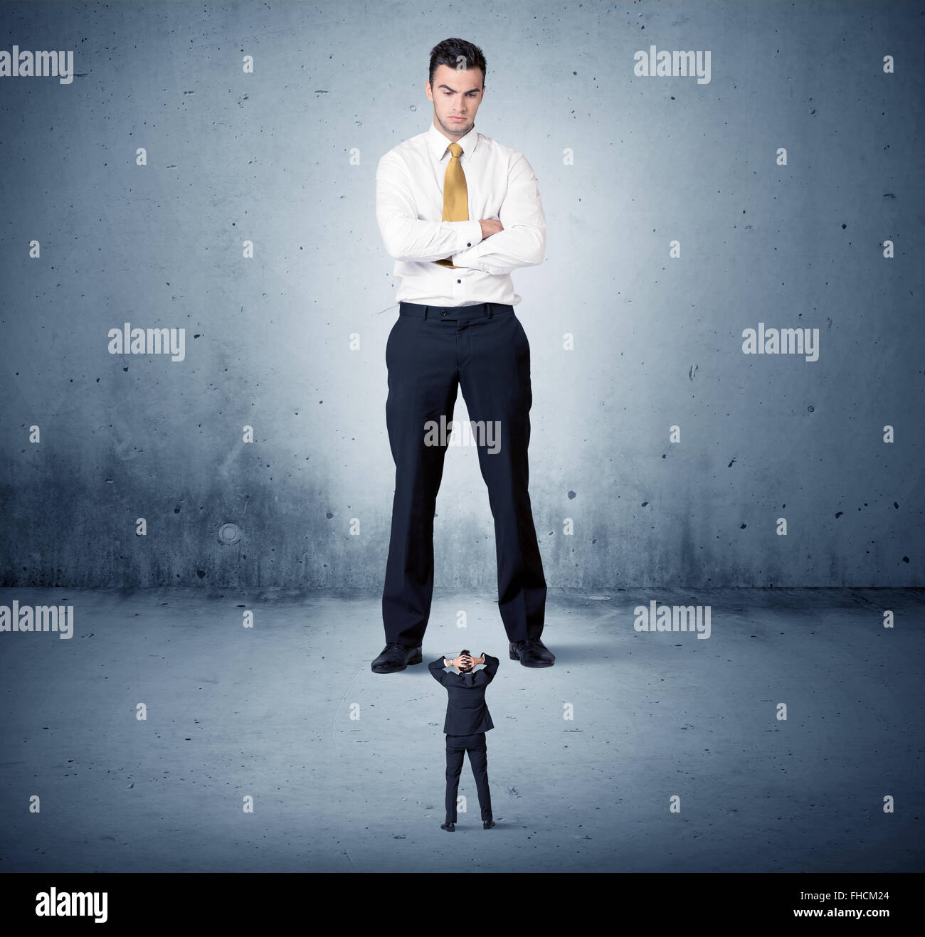 Angry huge business man lokking at small guy Stock Photo - Alamy
