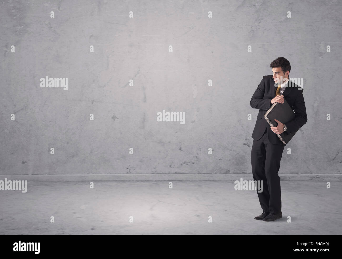 Young businessman standing confused Stock Photo - Alamy