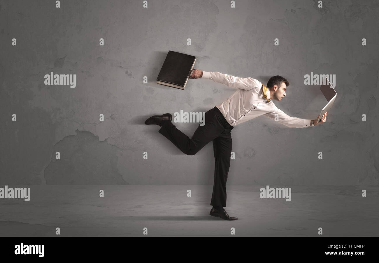 Running businessman with device in hand Stock Photo - Alamy