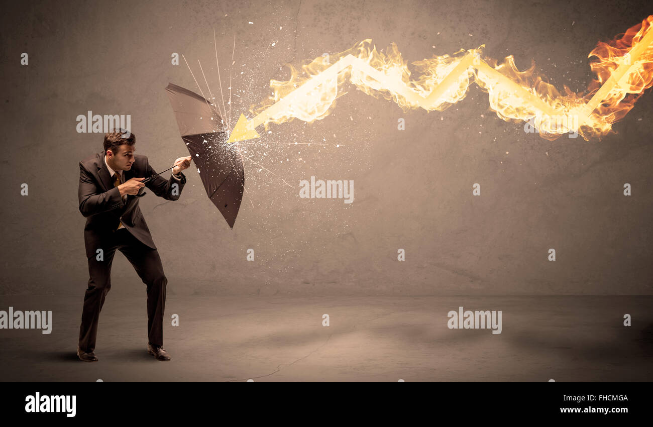 Business man defending himself from a fire arrow with an umbrella Stock ...